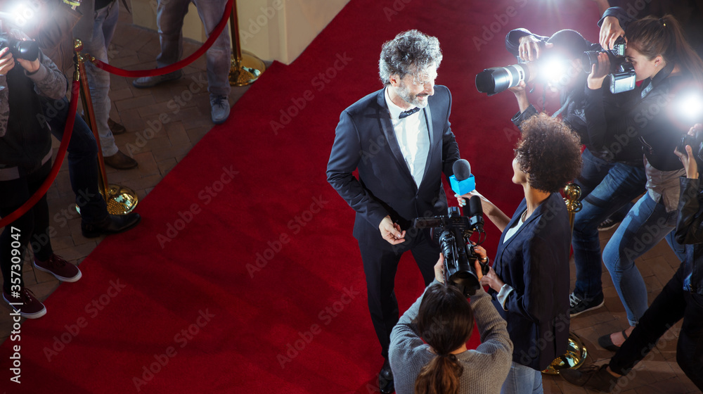 Celebrity being interviewed photographed by paparazzi photographers at ...