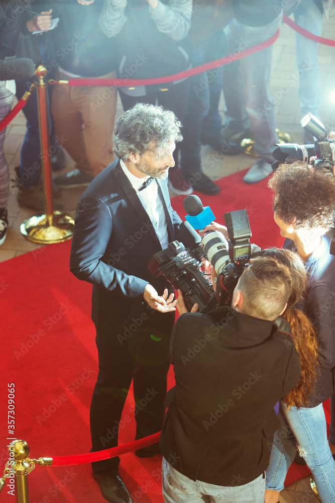 Celebrity being interviewed photographed by paparazzi photographers at ...