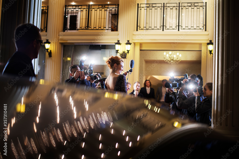 Celebrity arriving at event and being photographed by paparazzi Stock ...