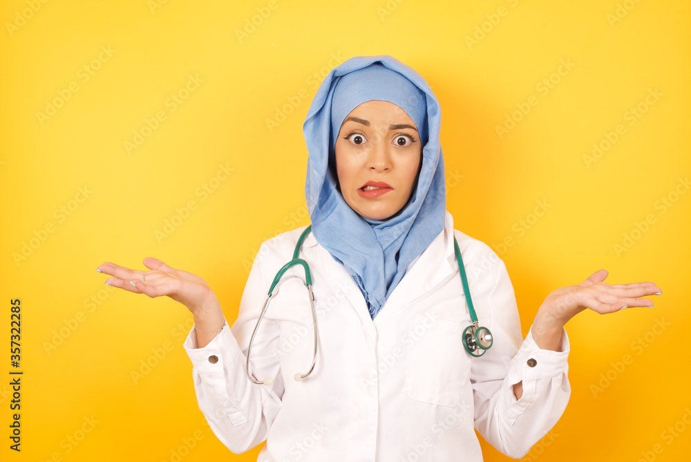 Clueless doctor man wearing medical uniform, shrugs shoulders with ...