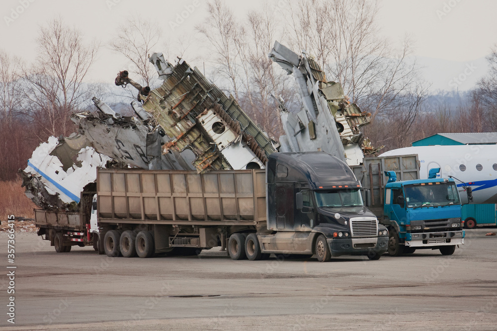 Parts of a disassembled jet loaded into a truck, aircraft scrap from a ...
