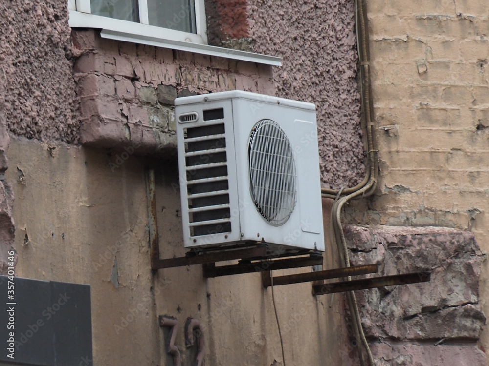 old outdoor air conditioning unit on the facade of the house Stock ...