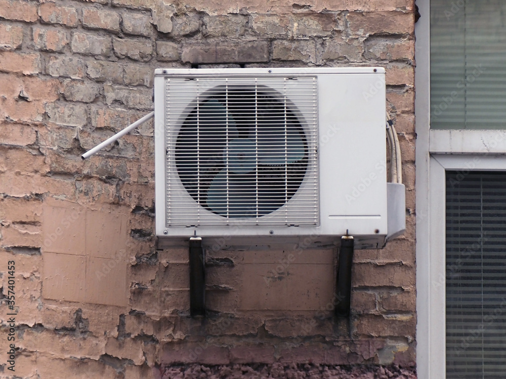 old outdoor air conditioning unit on the facade of the house Stock ...