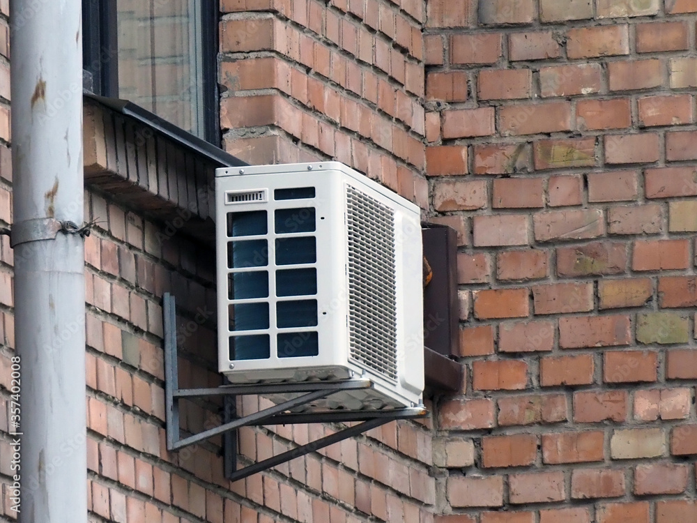 old outdoor air conditioning unit on the facade of the house Stock ...
