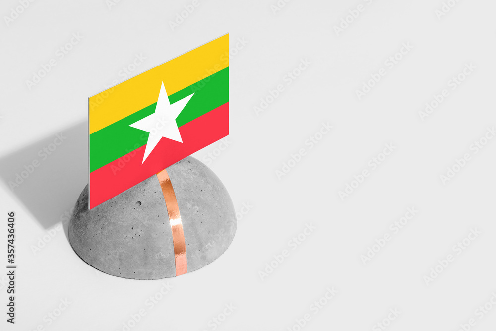 Myanmar flag tagged on rounded stone. White isolated background. Side ...