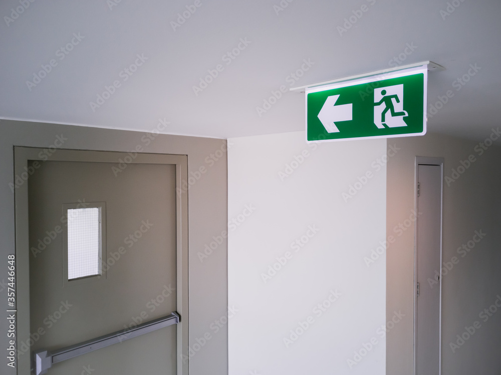 Close up view of the fire exit sign and the fire exit door that is ...