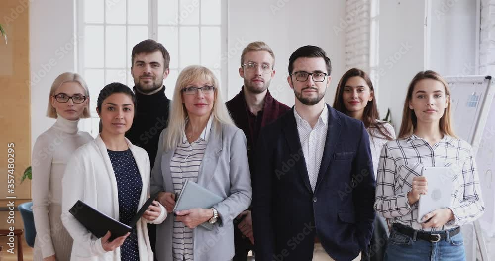 Group portrait of happy middle aged and young multiracial confident ...