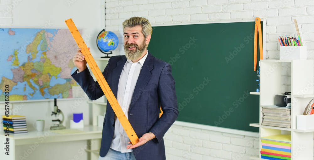 Handsome bearded man in classroom chalkboard. Modern teaching method ...