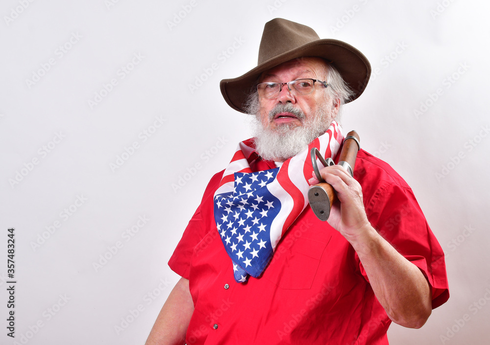 Serious looking man, armed with a sawed off rifle, wearing patriotic ...
