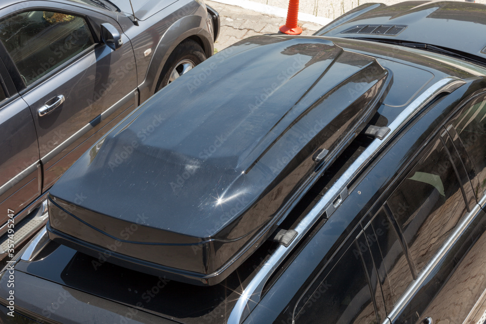 Roof-Mounted Cargo Box on The Car Roof. Car and cargo concept. You can ...