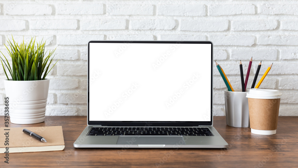 laptop computer with blank white screen, with workspace and office ...