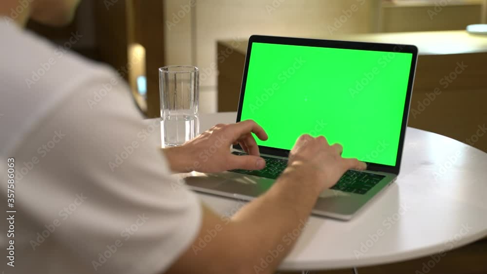 computer laptop green screen working with close-up man, using finger ...