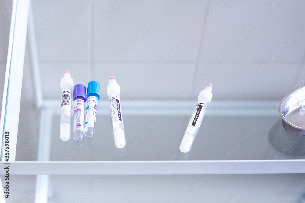empty plastic blood collection tubes for analysis on a glass treatment ...