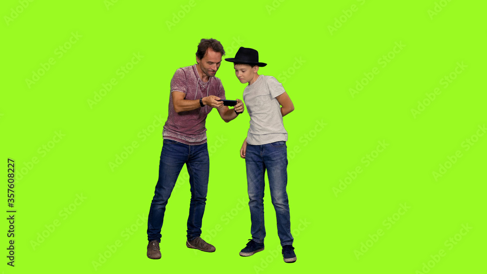 Father takes a picture of his little son with smartphone and showing on ...