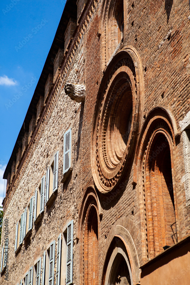 Close up. The red brick wall with unusual design in centre of Brescia ...