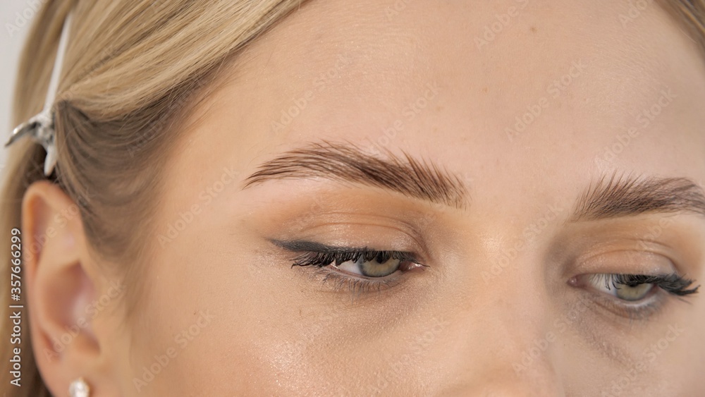 Half-open female beautiful eyes look aside close-up. Attractive female ...