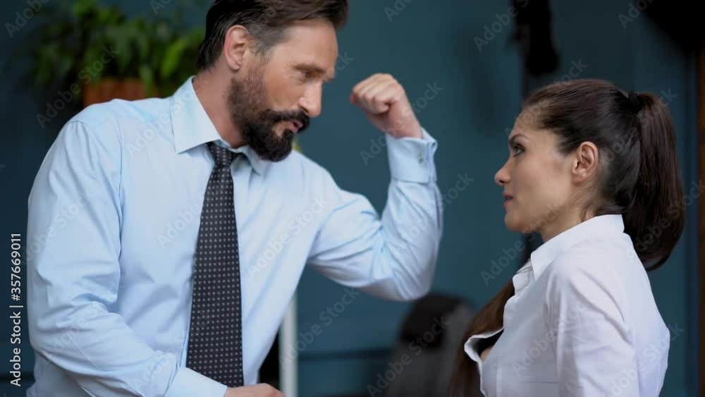Front view. Business man shows off to the employee the strength of his ...