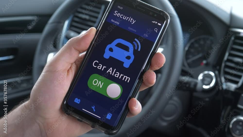 Using a smartphone to turn ON the car alarm security feature. Stock ...