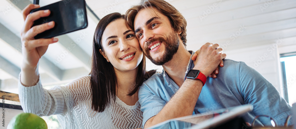 Couple working together at home in bright wooden room in their own ...