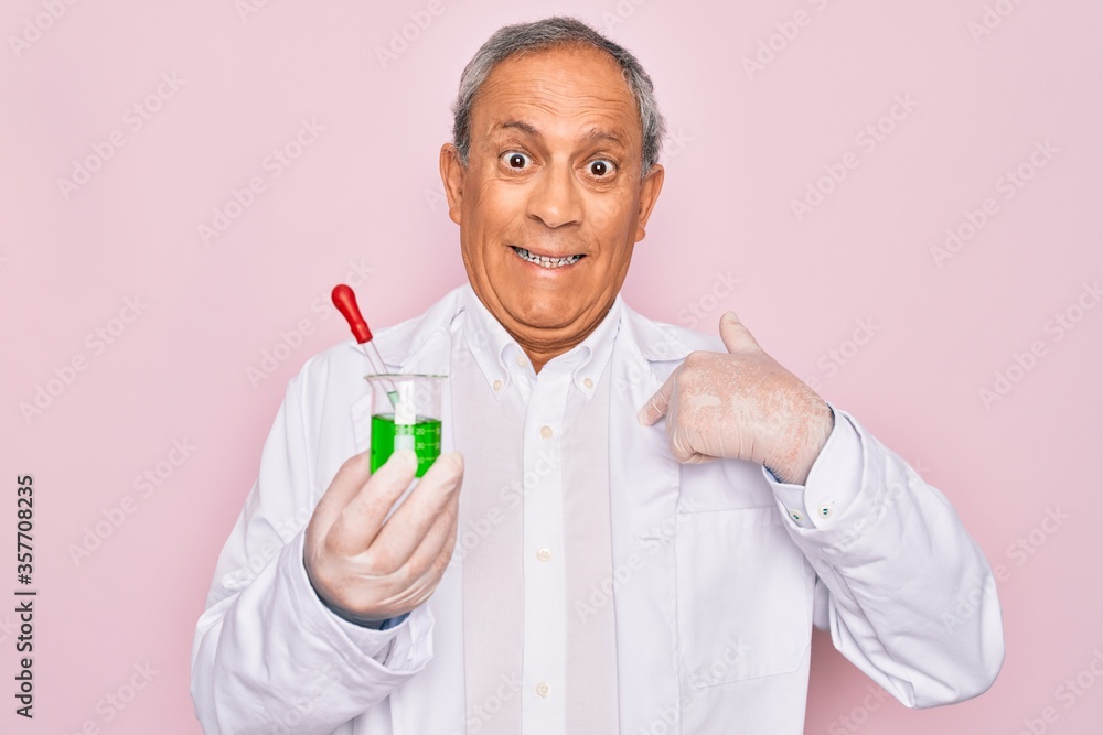 Senior grey-haired scientist man wearing holding sample tube test over ...