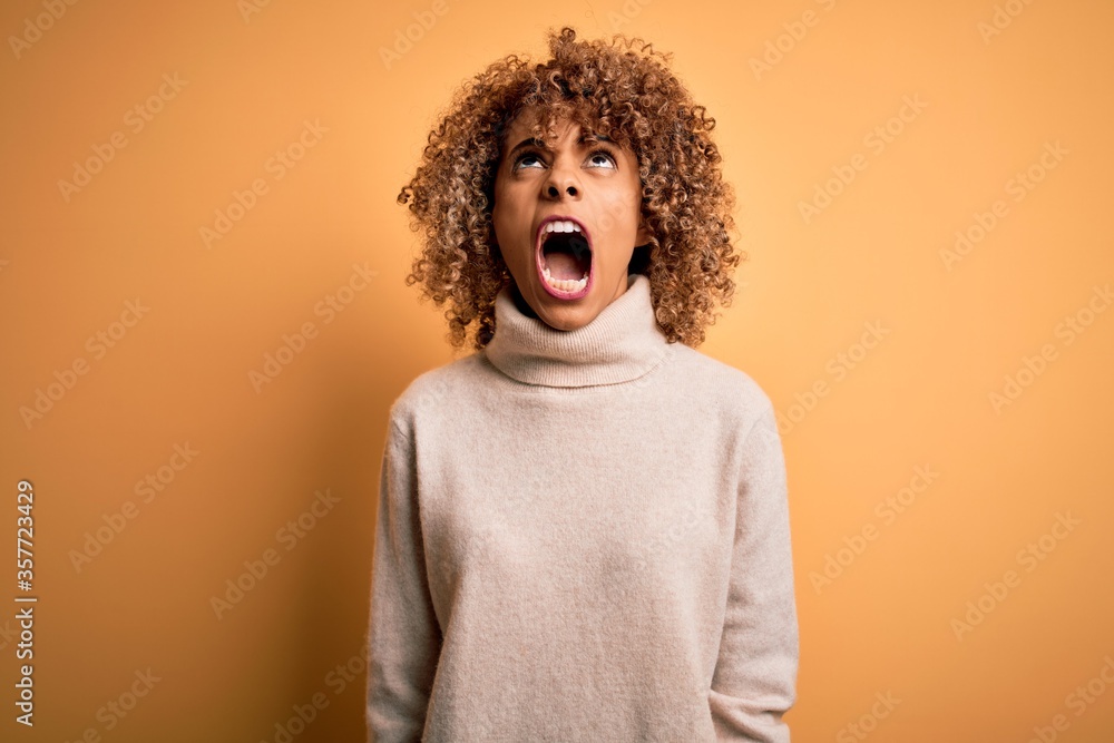 Young beautiful african american woman wearing turtleneck sweater over ...