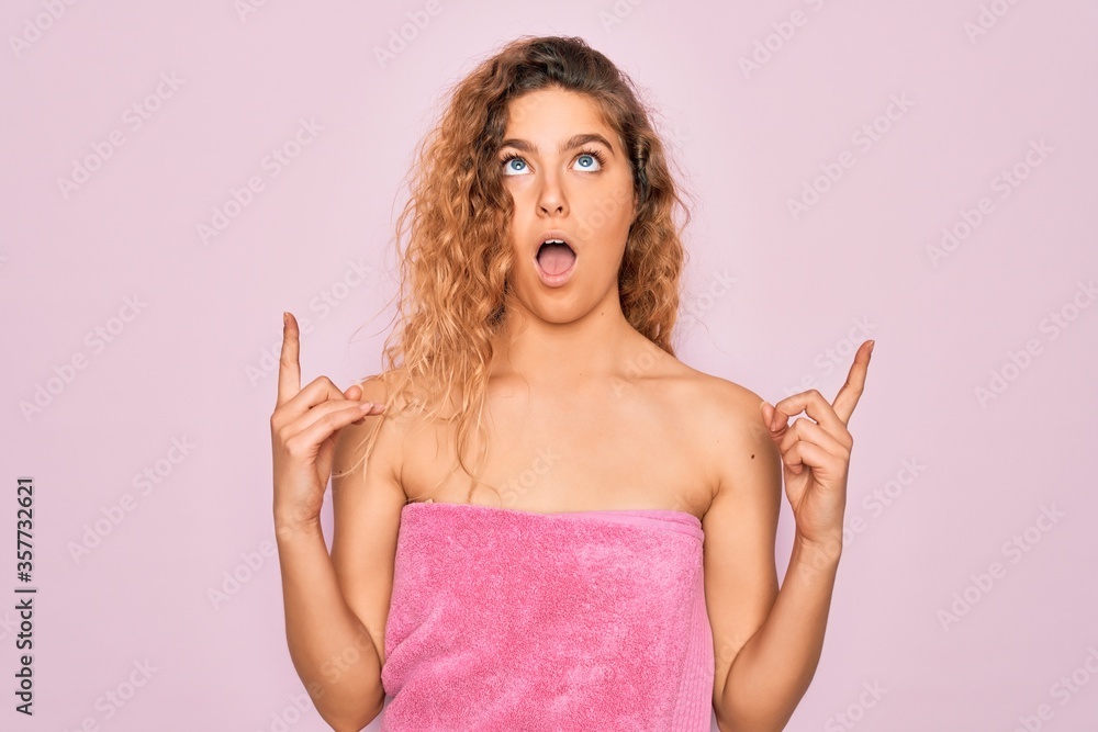 Beautiful blonde woman with blue eyes wearing towel shower after bath ...