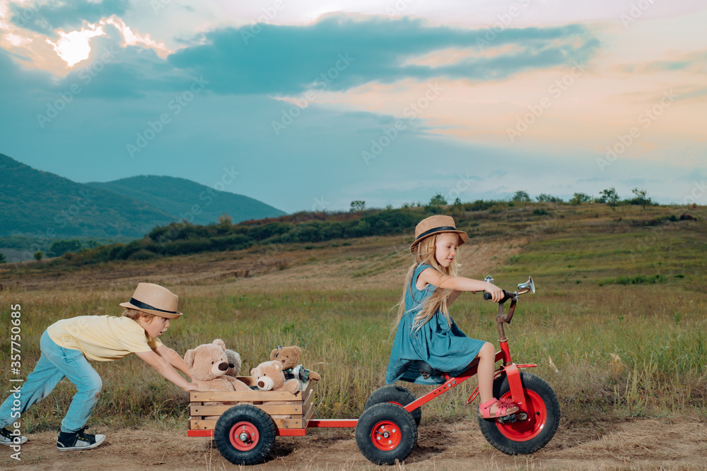 Positive little girl and boy. Little children have fun on fresh air ...