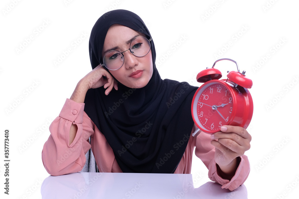 Muslim woman hold alarm clock with deference expression face with ...