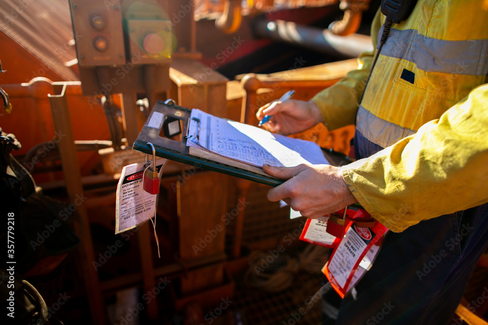 Site safety auditor supervisor verifying name of co workers on ...