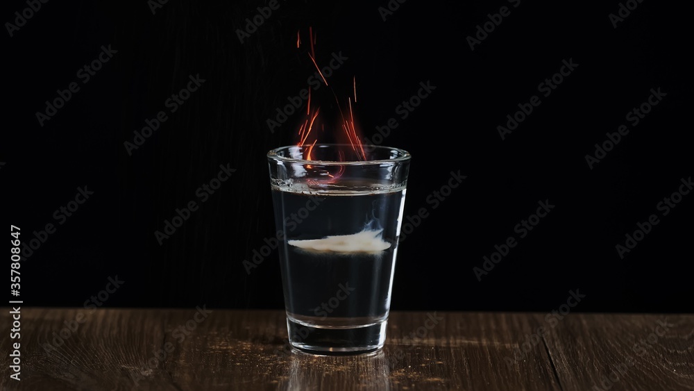 The bartender fire to an alcoholic cocktail with sambuca and Irish ...