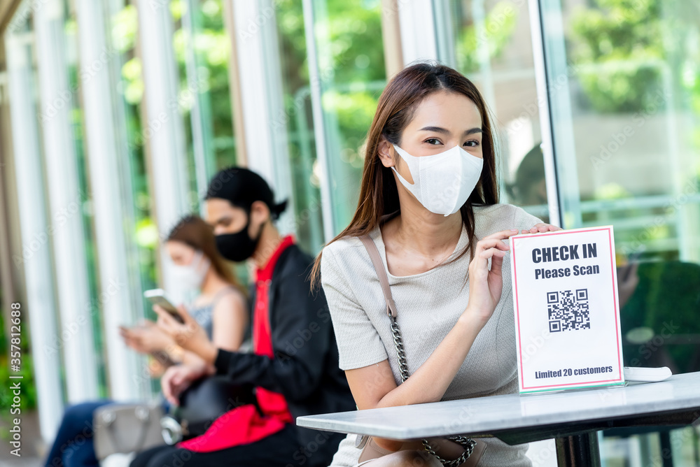 Cute teenage woman wear mask show sigh with text 'check in please scan ...