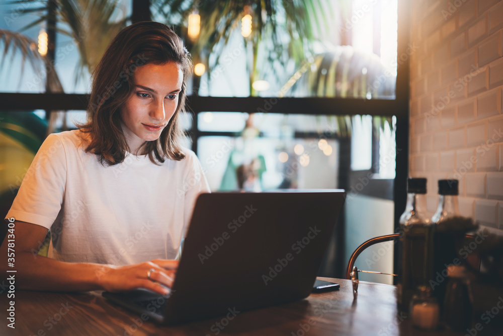 girl looking on screen monitor using laptop at cafe workplace ...