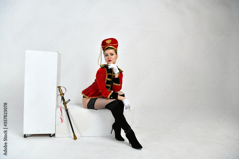 beautiful girl in a red hussar costume with a sword Stock Photo | Adobe ...