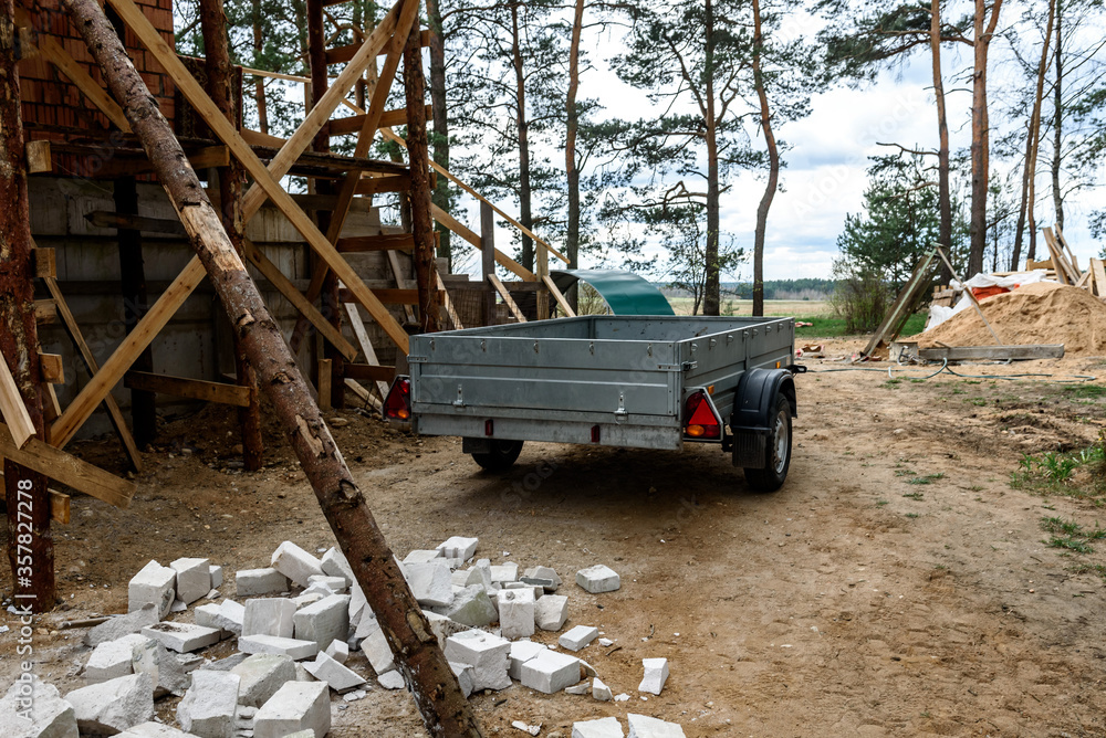 Car trailer on construction site. Stock Photo | Adobe Stock