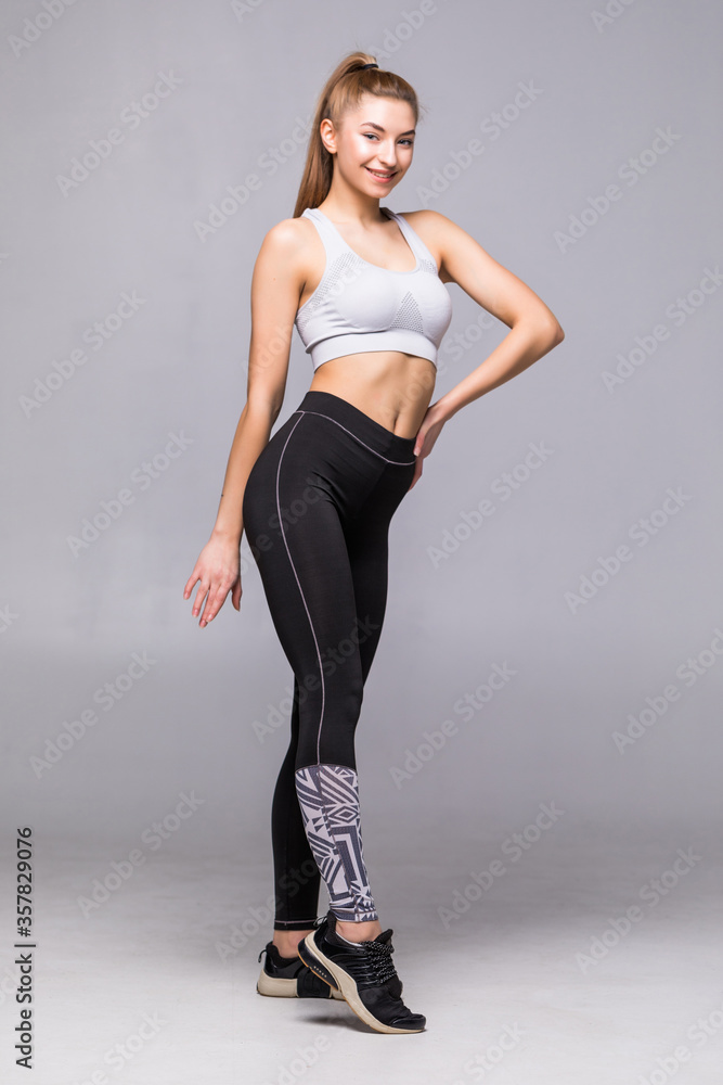 Young woman with beautiful slim healthy body posing in white background ...