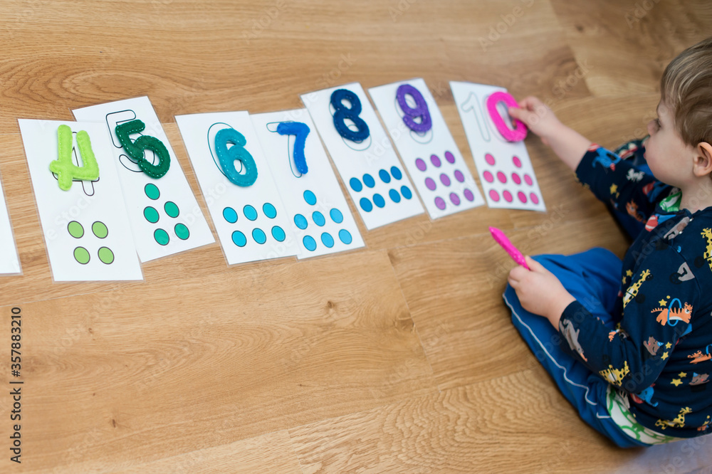 Early mathematic. Little boy playing with numbers and dot cards. Home ...