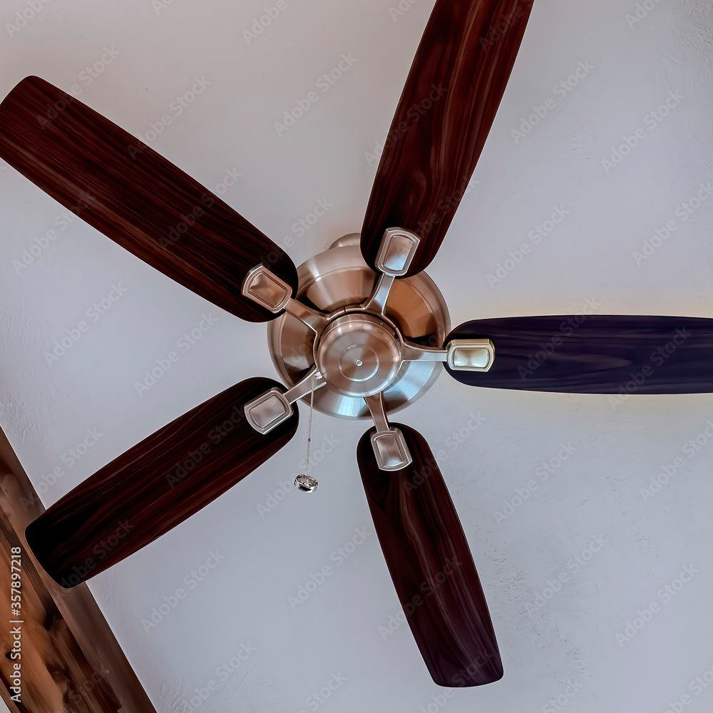 Square Living room ceiling fan flanked by decorative wood beams and ...