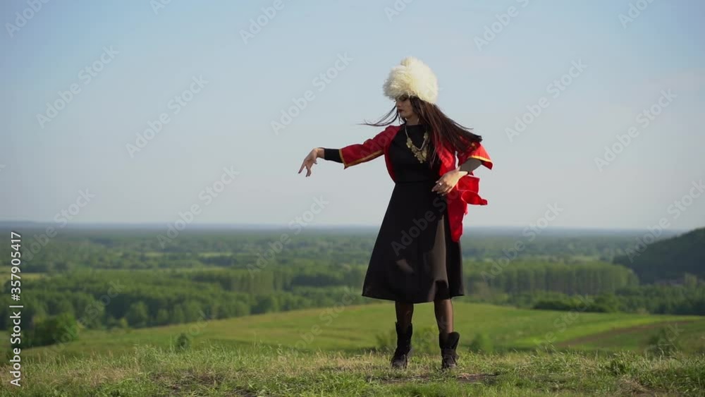 Georgian girl in white papakha and red national dress dances national ...