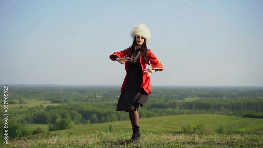 Georgian girl in white papakha and red national dress dances national ...
