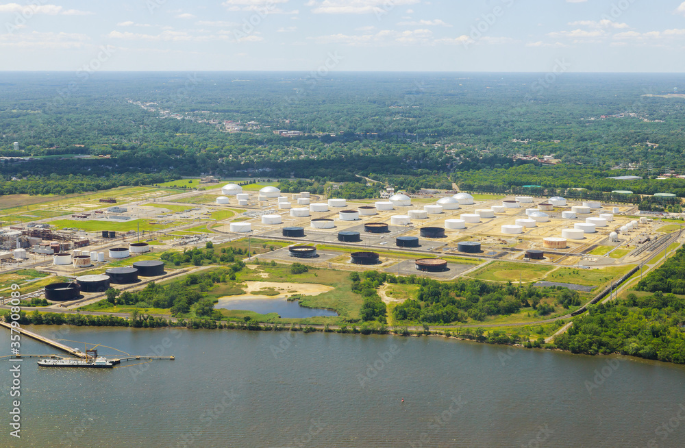 Tanker ship loading and unloading oil and gas storage at industrial ...