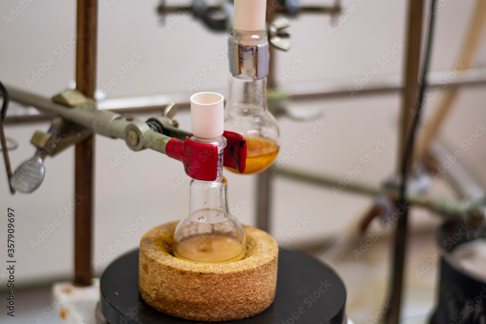 Round bottom flask with yellow liquid for for advance chemical ...