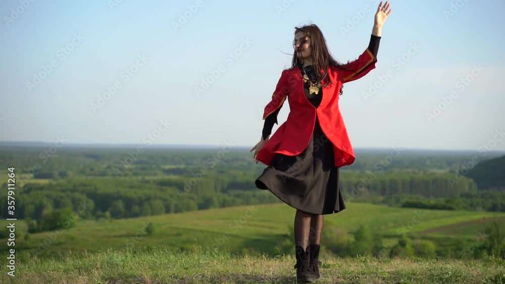 Georgian woman dances national dance in red national dress on the green ...