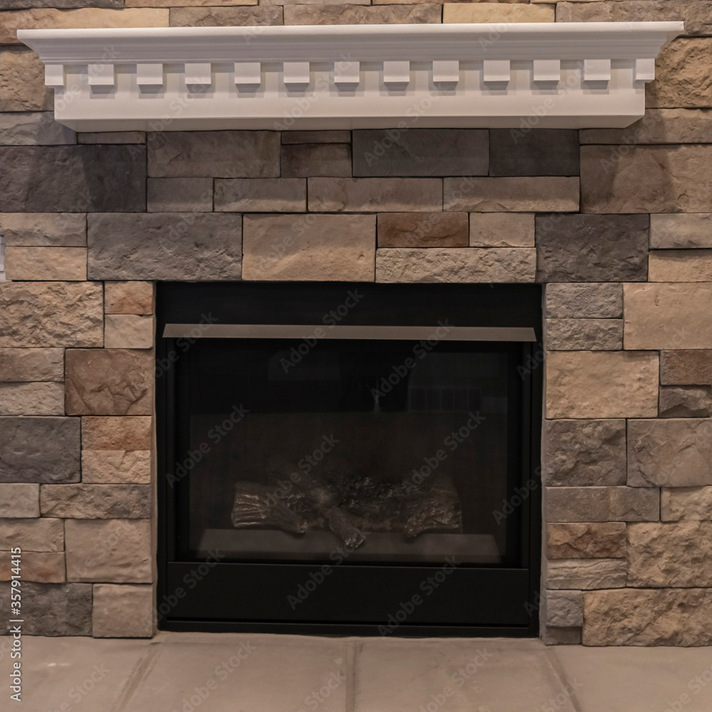 Square Fire insert in a feature stone brick wall Stock Photo | Adobe Stock