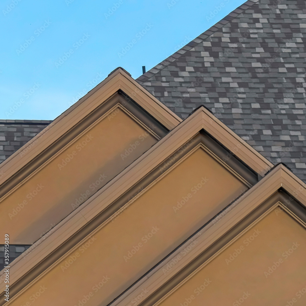 Square Home exterior with front gable roof and transom window against ...