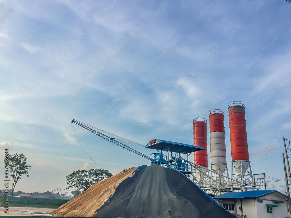 Cement concrete mixing production factory with dramatic sky background ...