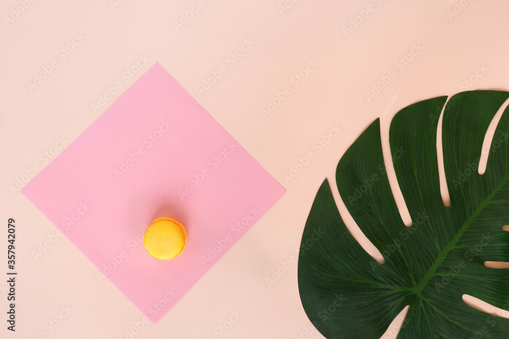 Top view composition consisting of a square pink sheet of paper, a ...