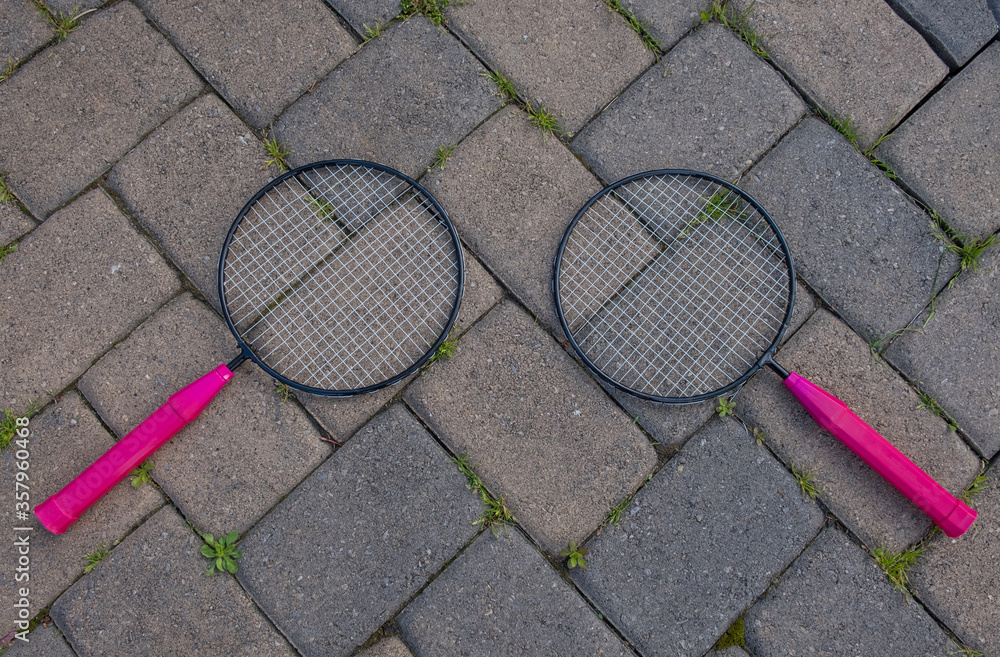 Isolated small badminton tennis rackets laying on grass ground. Rackets ...