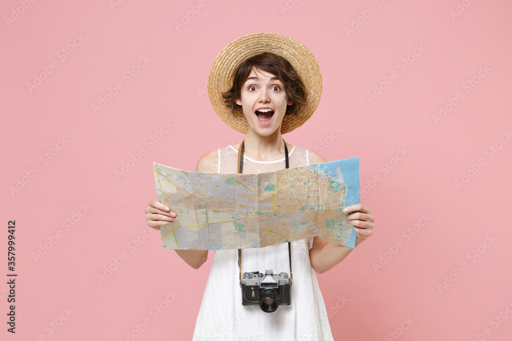 Surprised young tourist girl in summer dress hat with photo camera ...
