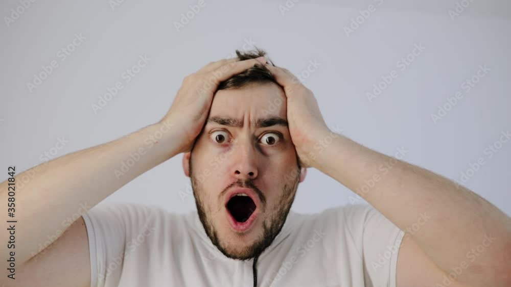 shocked man put hands on head and very surprised puts his hands to his ...