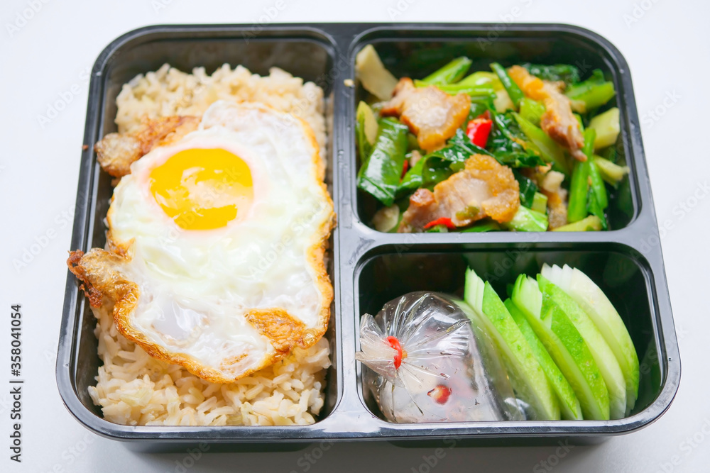 Thai lunch box - Crispy pork on rice, Chinese kale and egg Stock Photo ...